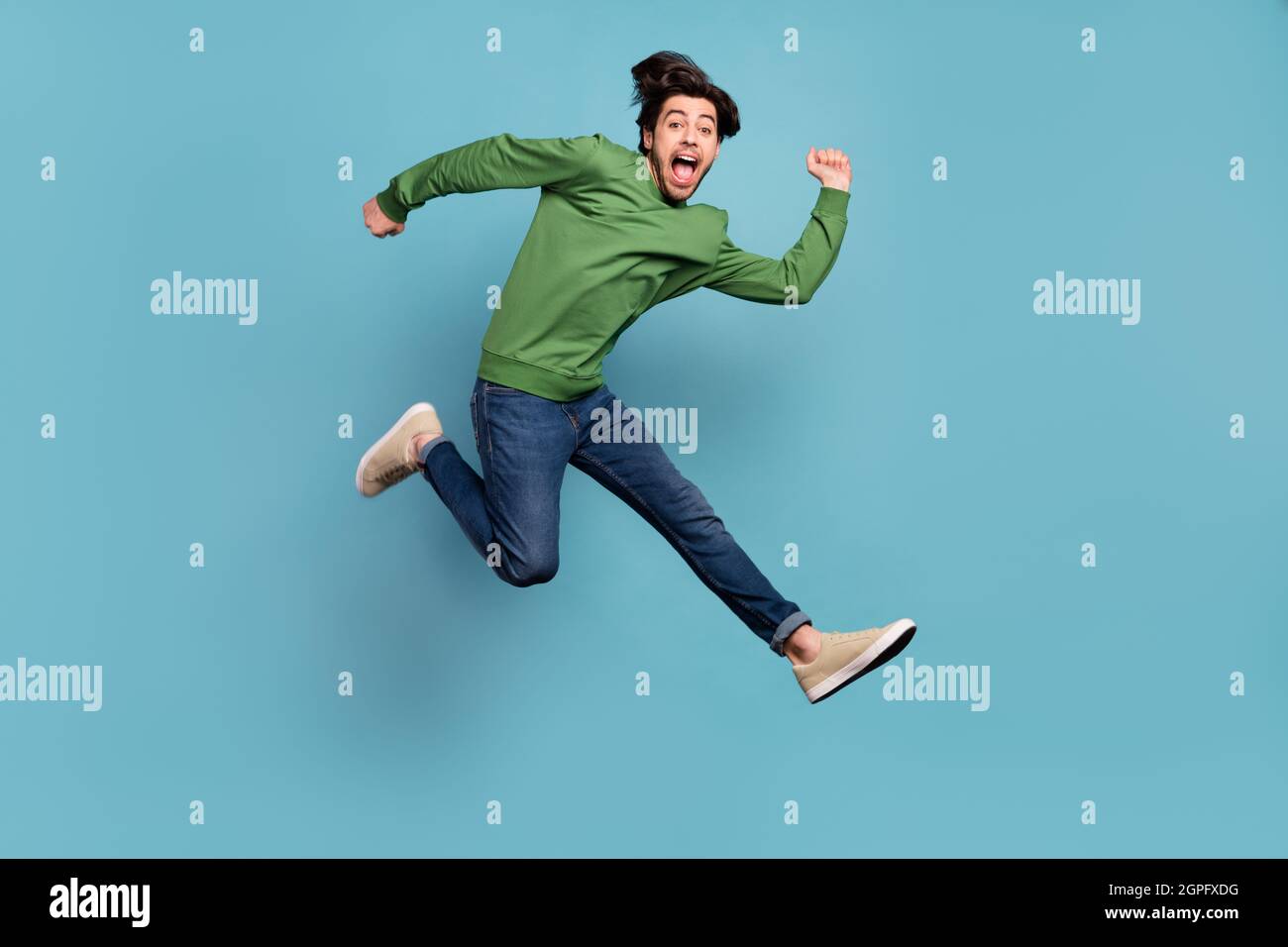 Full length photo of positive happy crazy man jump up good mood run ...