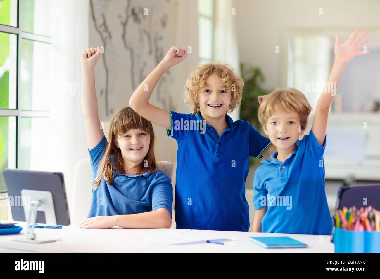 Online remote learning. School kids with computer having video ...