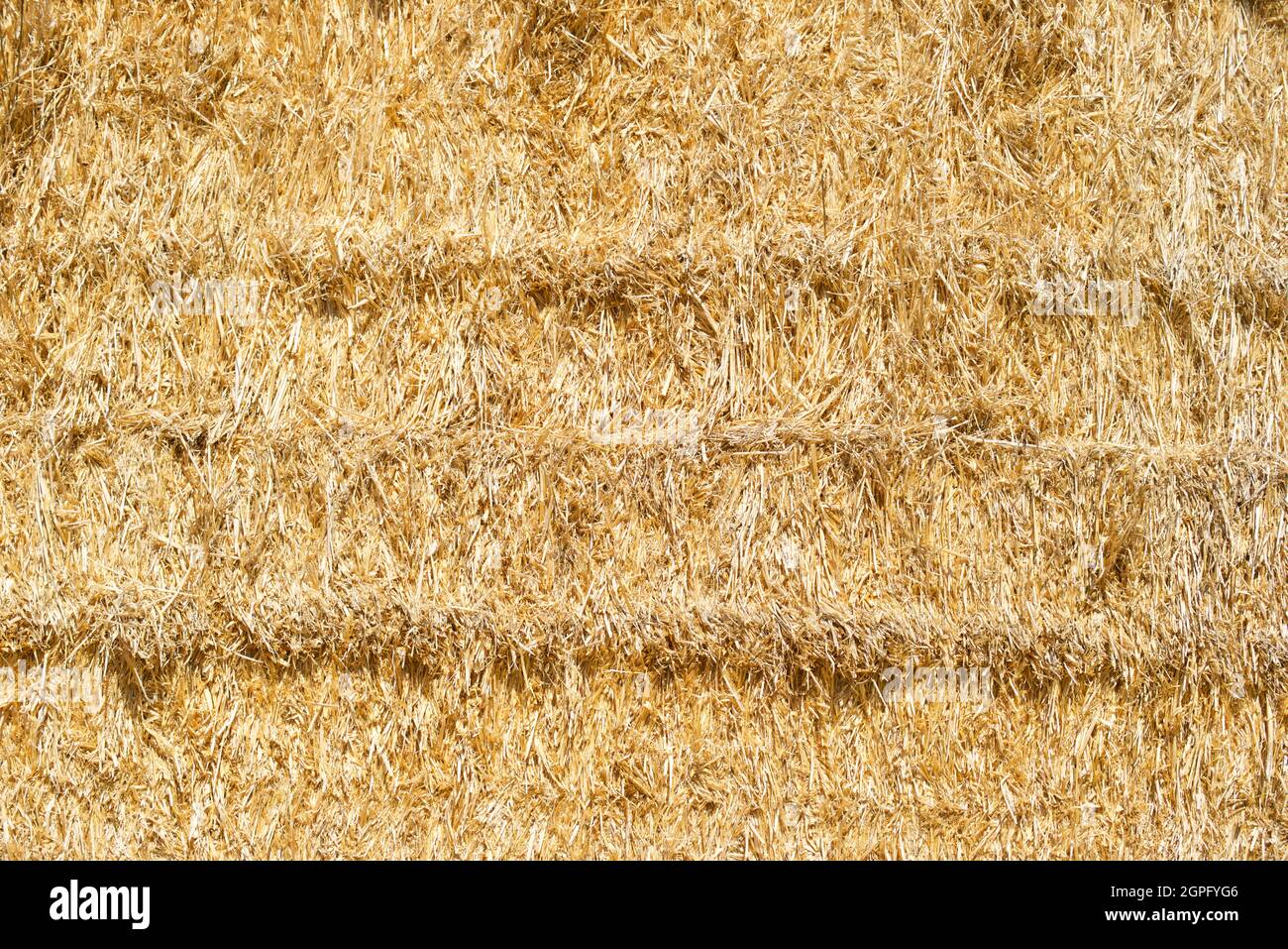 Background created with straw bales stacked Stock Photo - Alamy
