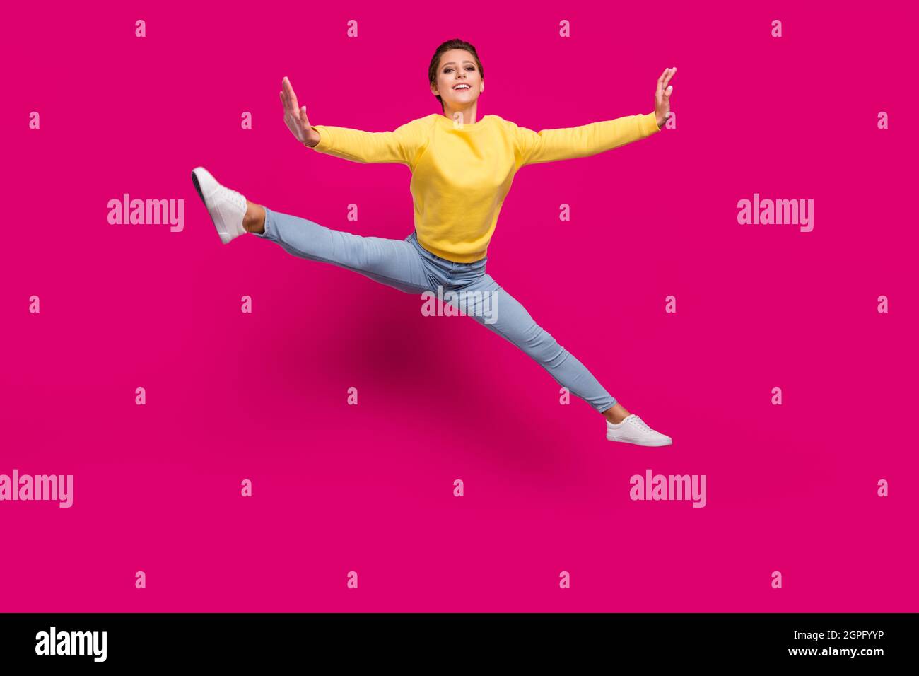 Photo of funny adorable young lady wear yellow jumper smiling jumping ...