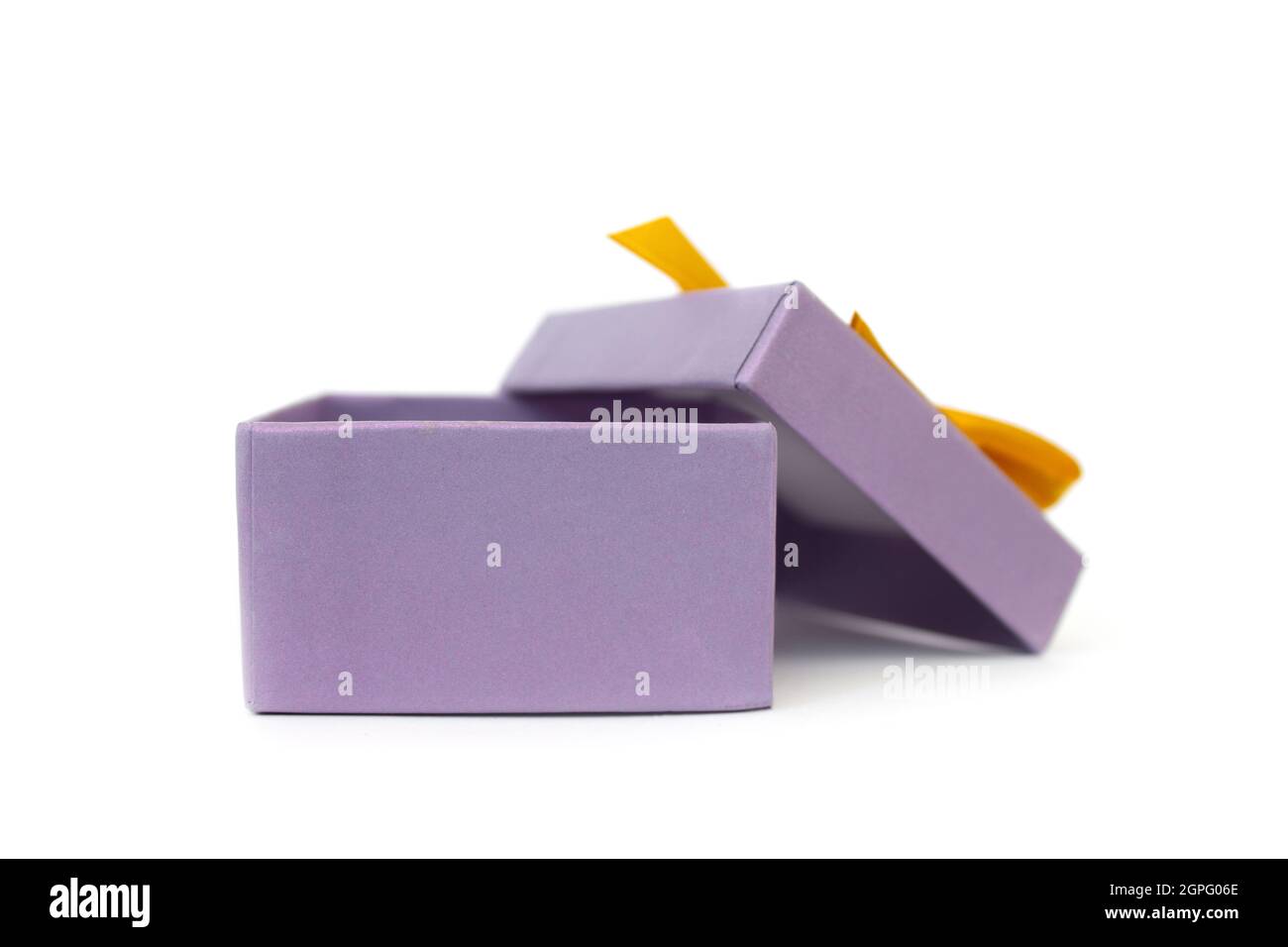 Blank open purple gift box with yellow ribbon bow isolated on white ...