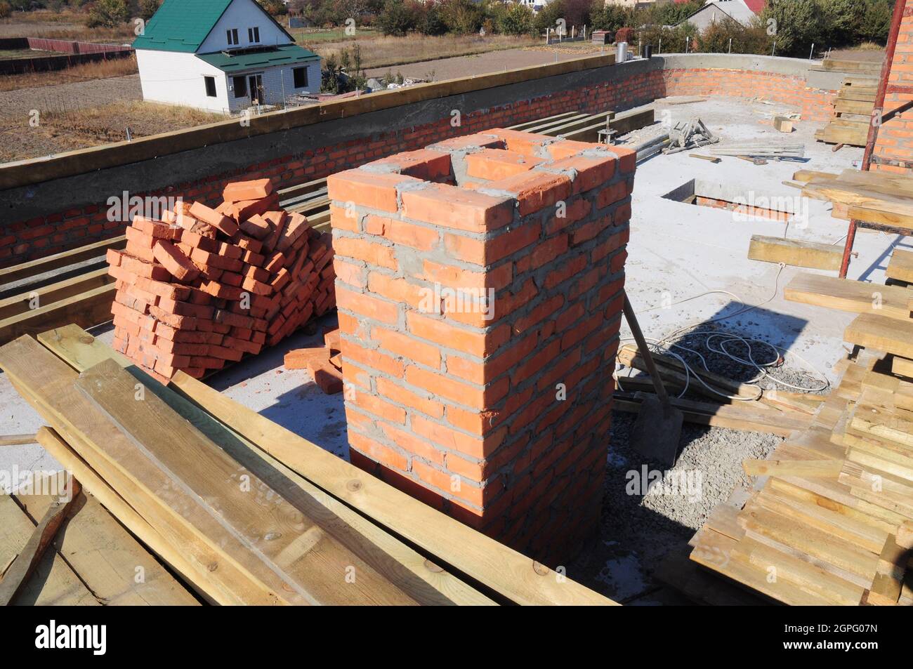 Building chimney from bricks. Bricklaying new house chimney Stock Photo ...