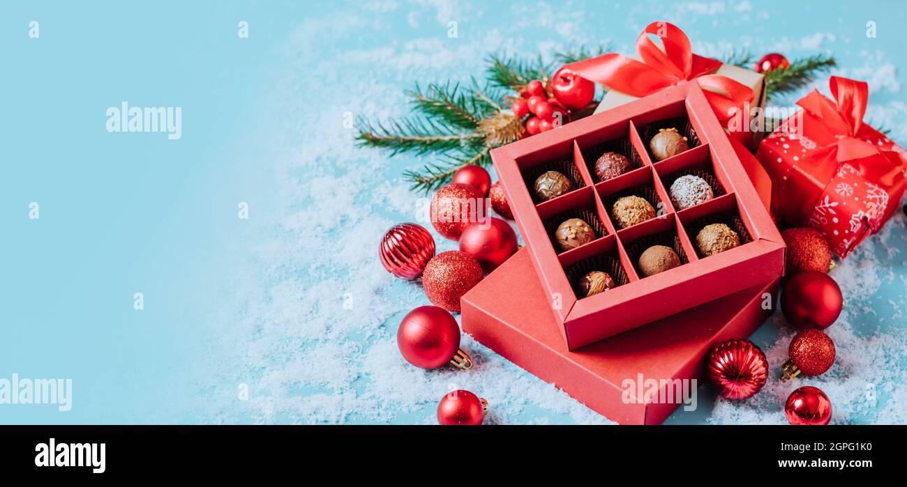Chocolates in a red festive box dark chocolate truffle on a Christmas ...