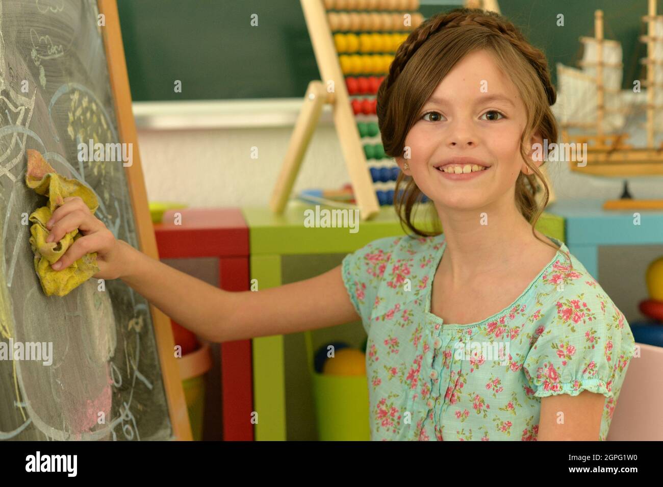 Portrait of happy student girl drawing on blackboard Stock Photo - Alamy