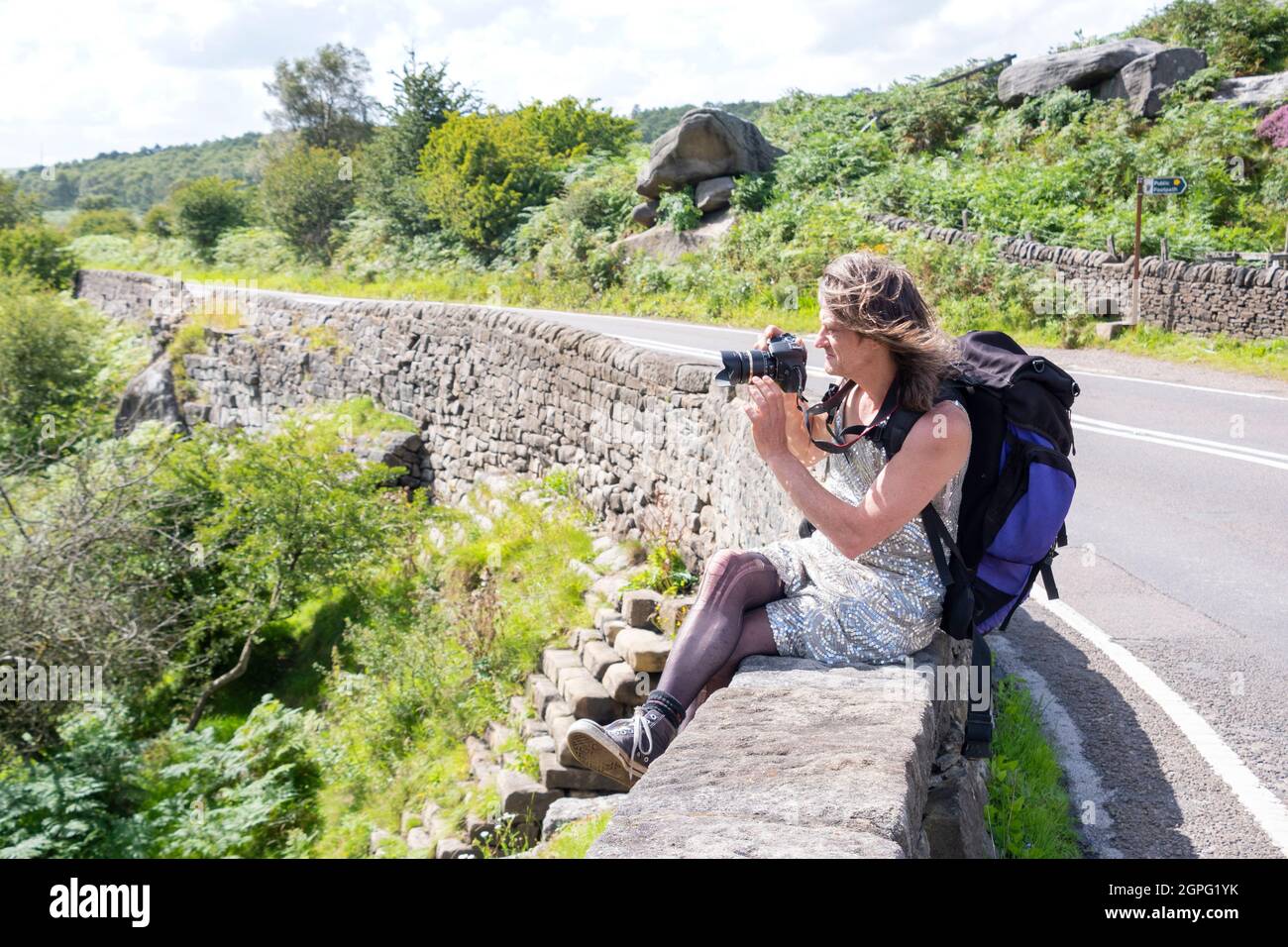 Derbyshire UK – 20 Aug 2020: Simon sat on a roadside wall of the A6187 ...