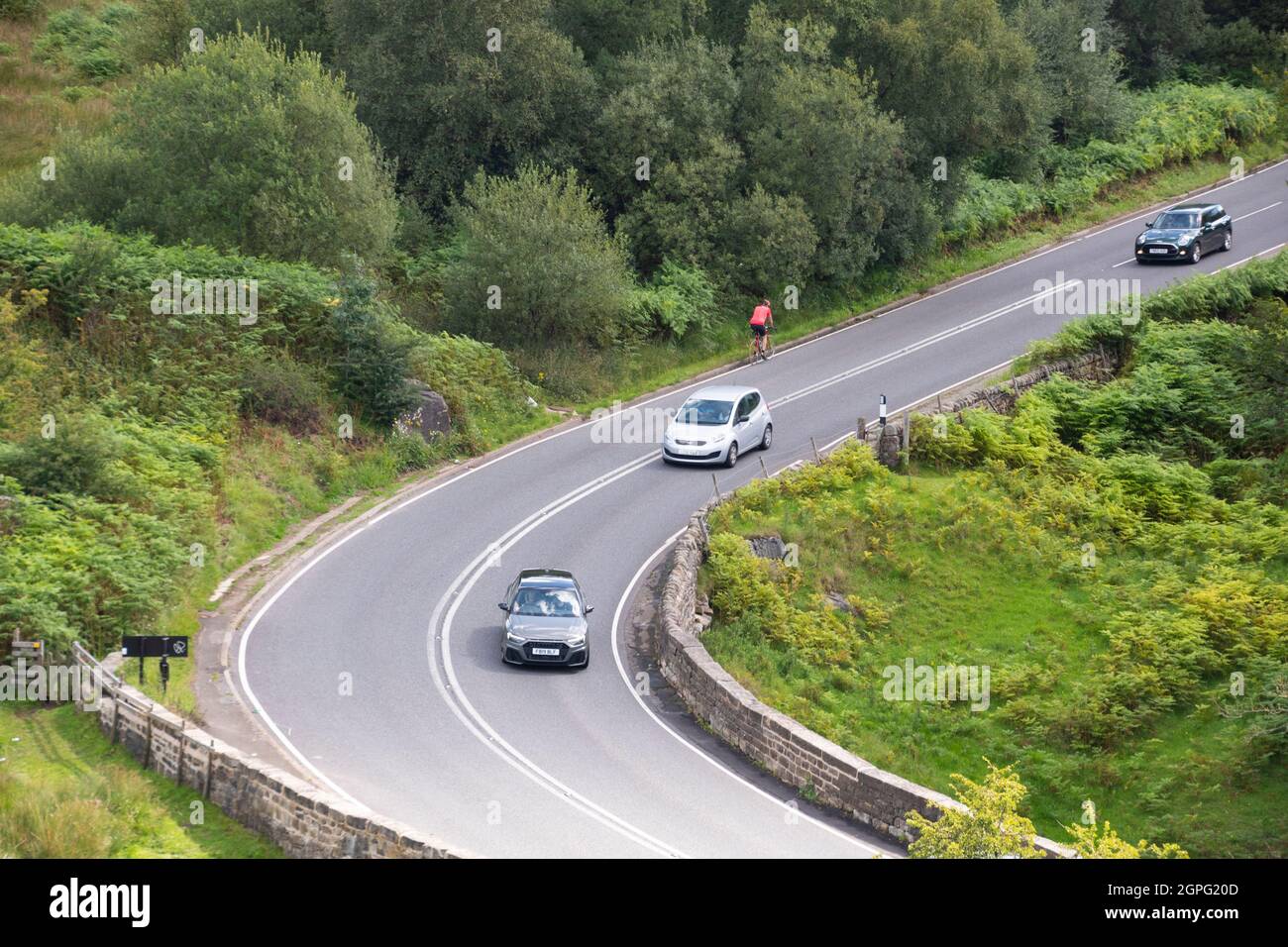 Derbyshire UK – 20 Aug 2020: a cyclist and three cars driving on the ...
