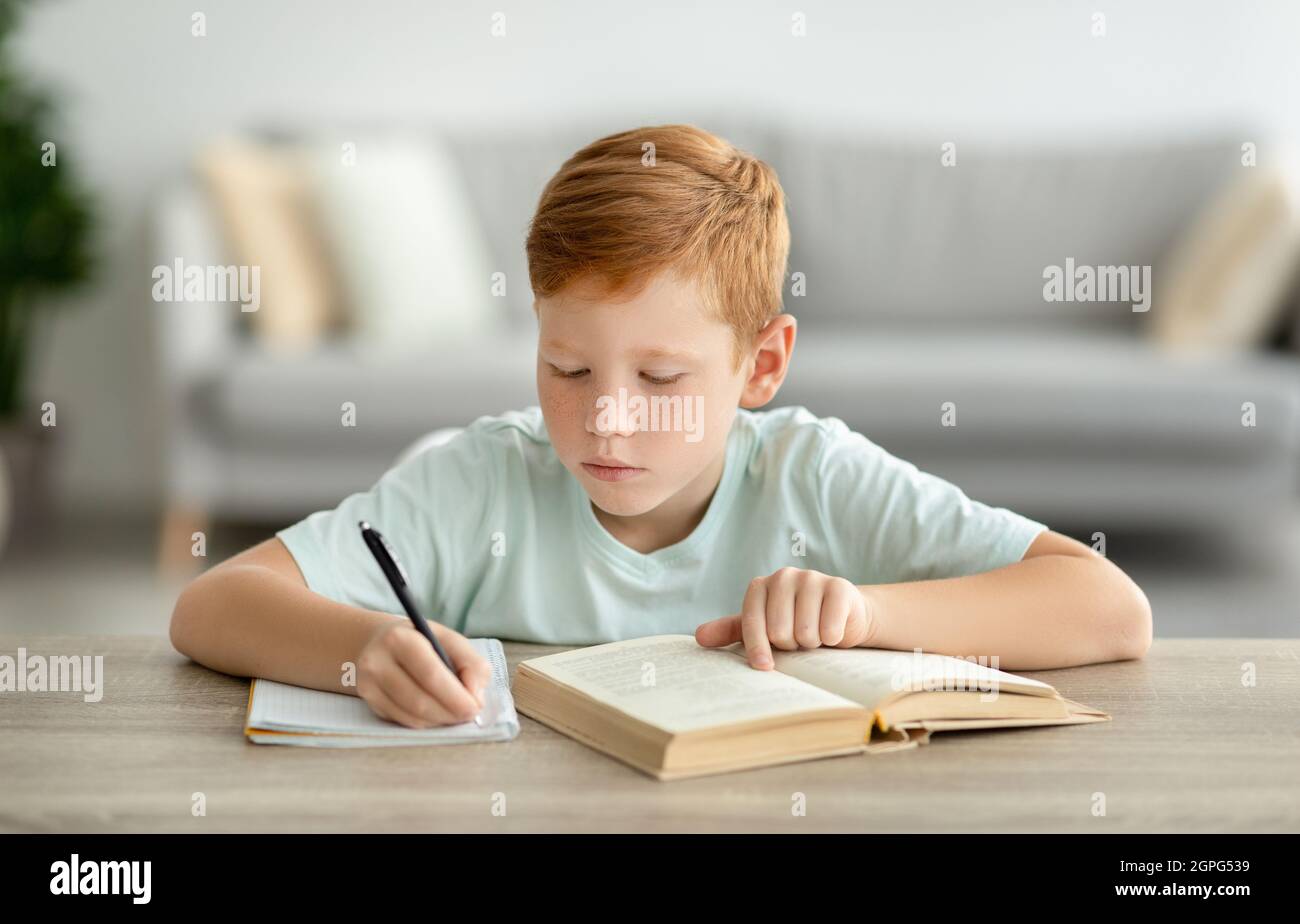 Boy writing notes hi-res stock photography and images - Alamy
