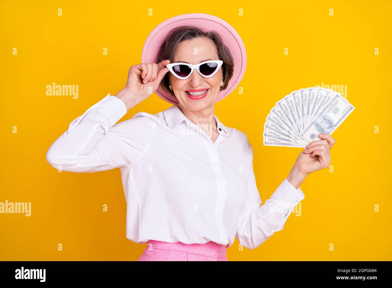 Photo of aged business woman happy positive smile hold money cash ...
