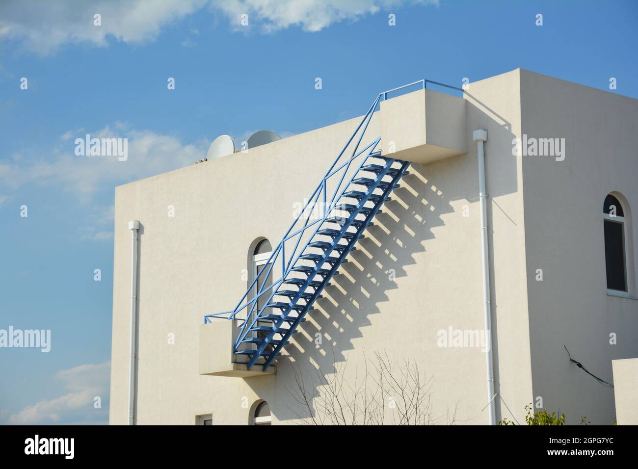 Steps on flat rooftop outdoors. Modern house with exterior ladder from ...