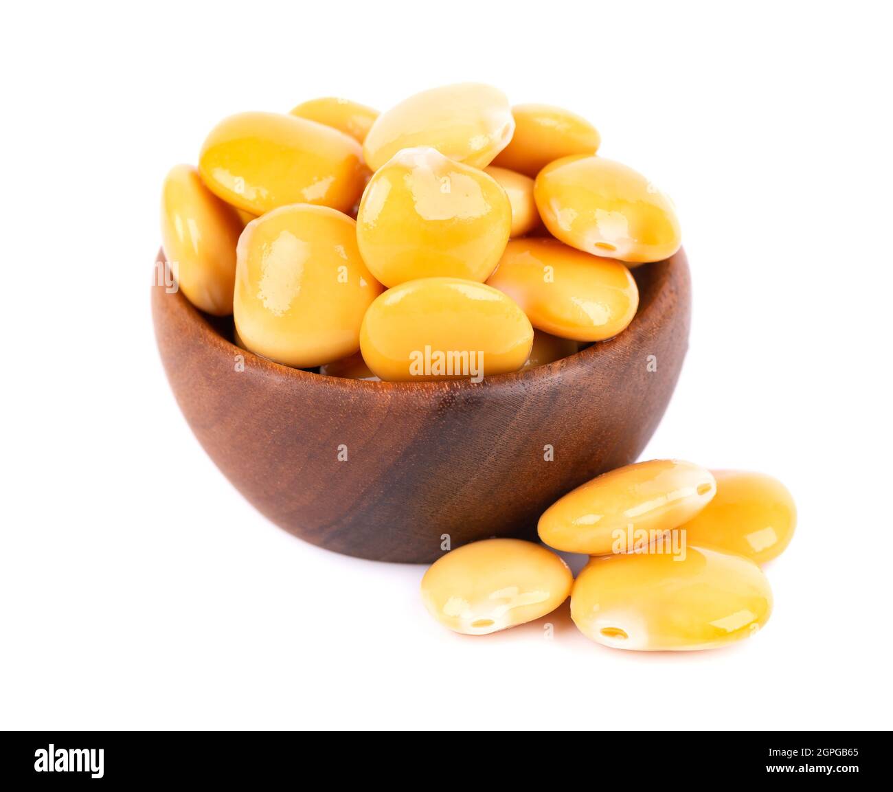 Pickled yellow lupine beans in wooden bowl, isolated on white ...