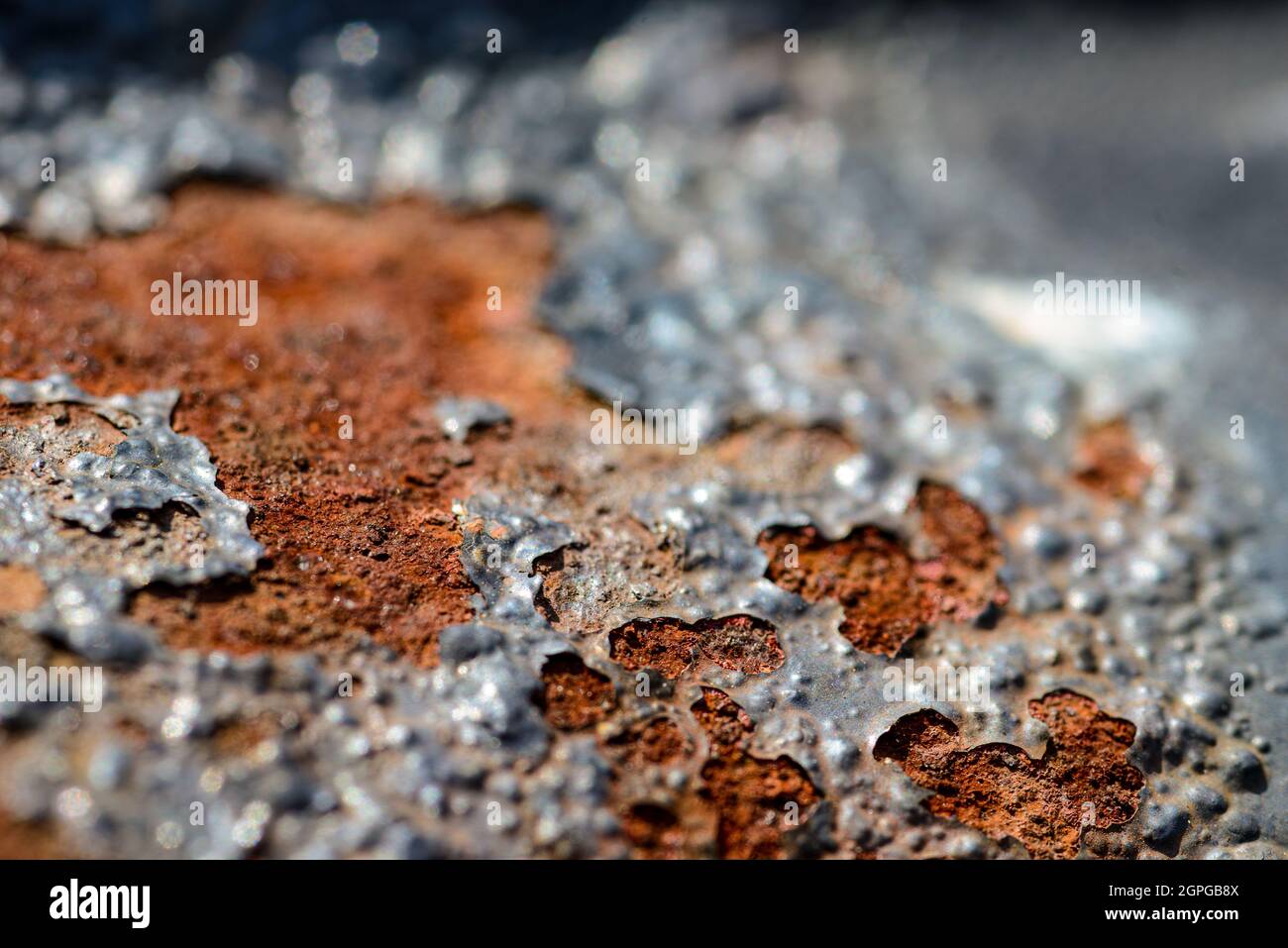 Macro photography of a metal starting to rust, where parts are still ...