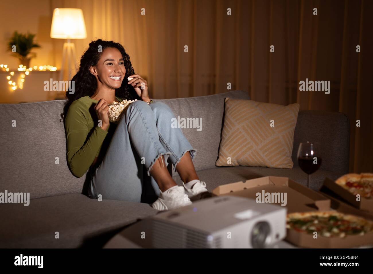 Happy Woman Watching Movie Via Projector Having Fun At Home Stock Photo ...