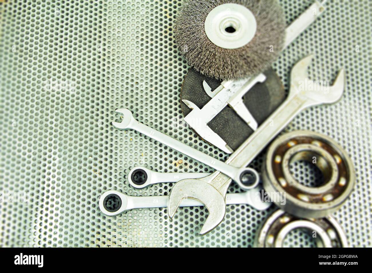 Metalworking tools, steel parts, a wrench, on the background of a metal ...