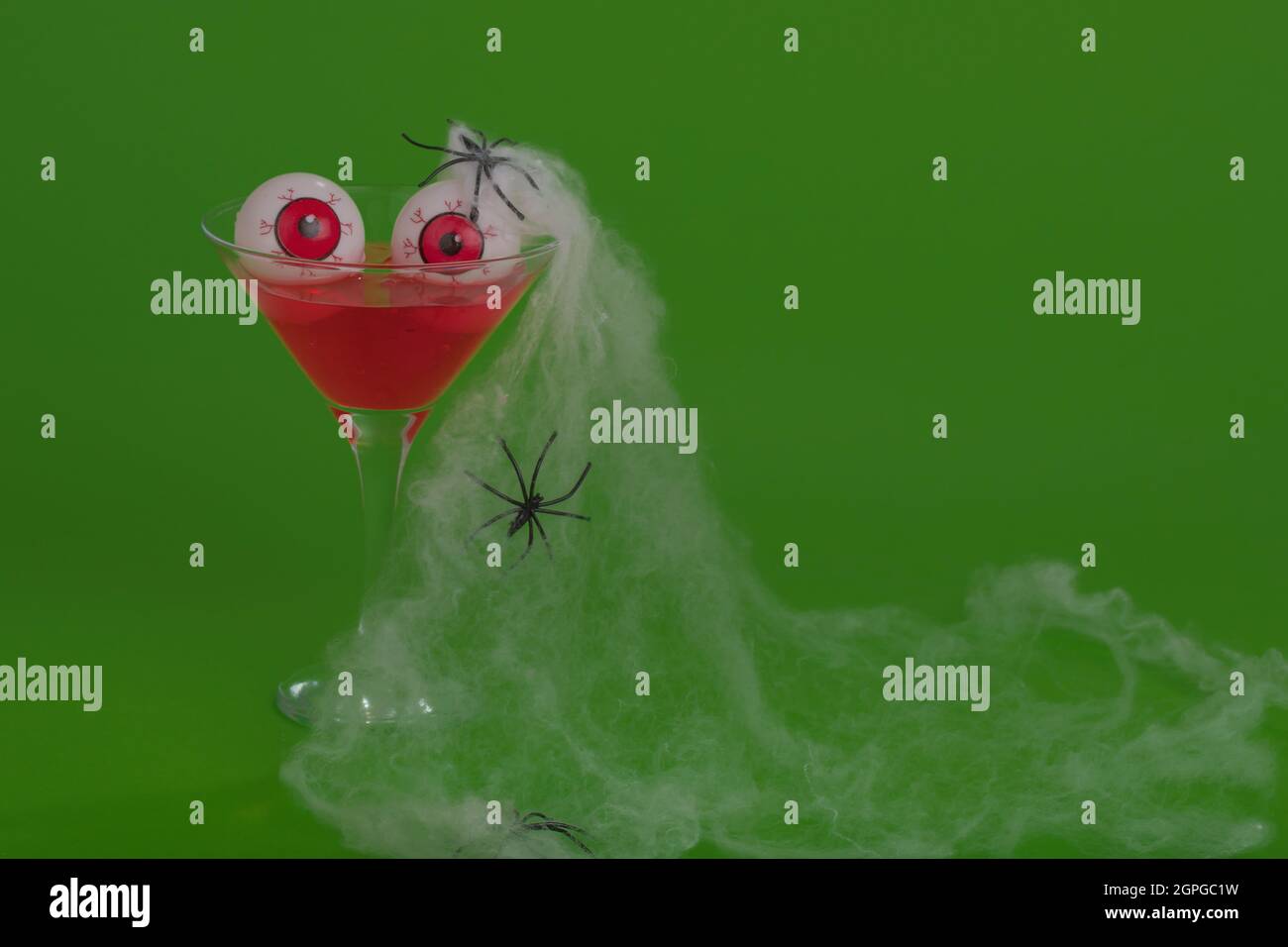 Red Bloody cocktail with eyeballs with cobweb or spider's web on a ...