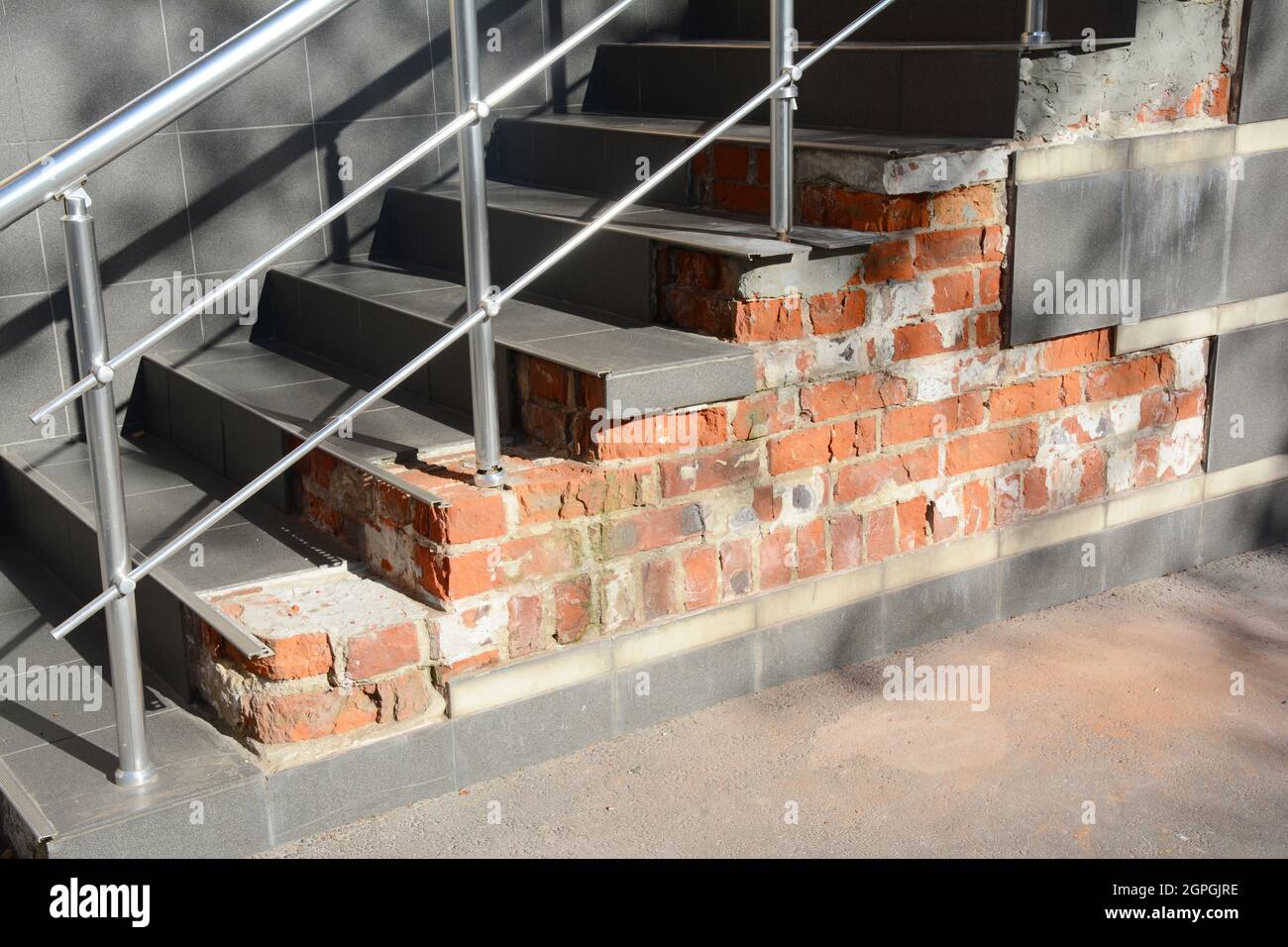 Broken house steps foundation with water leaks outdoor. Damaged stair ...