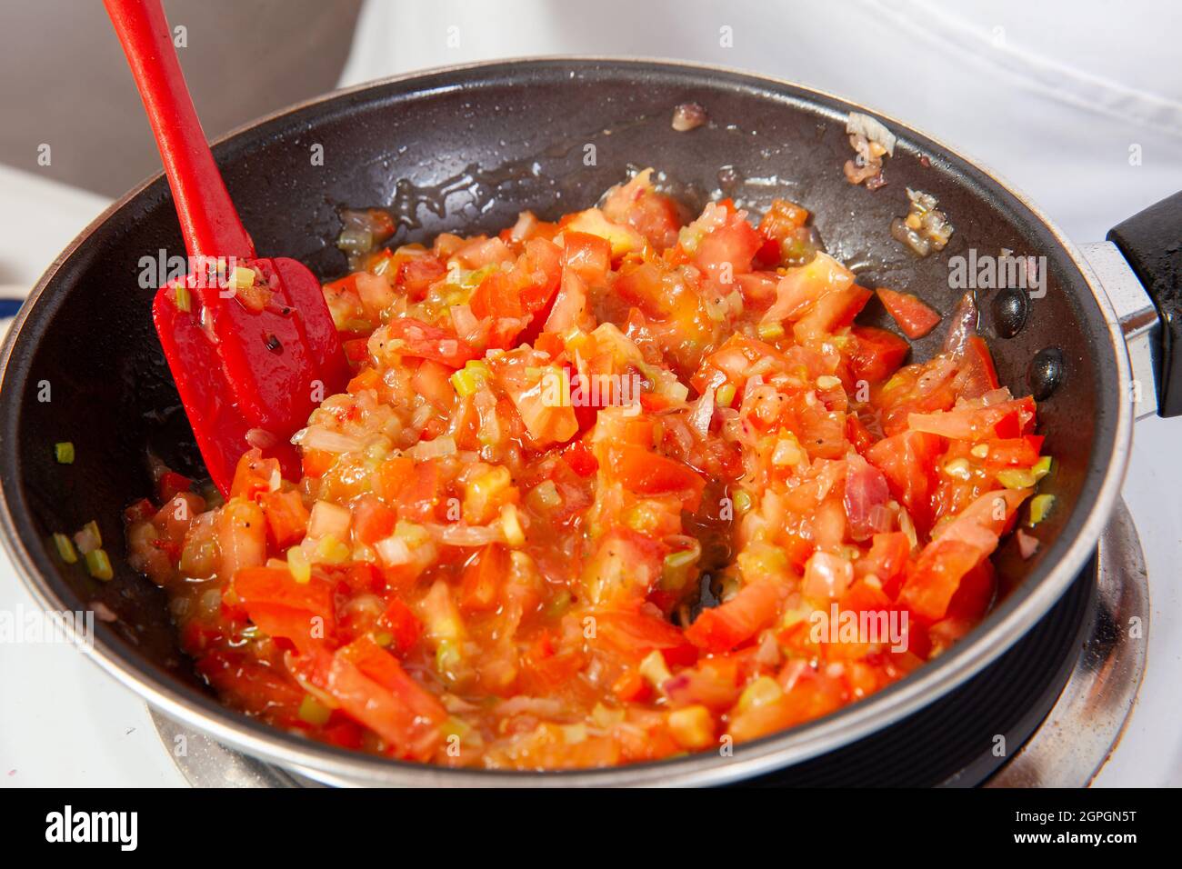 Preparation of the traditional Colombian hogao or criollo sauce (salsa ...