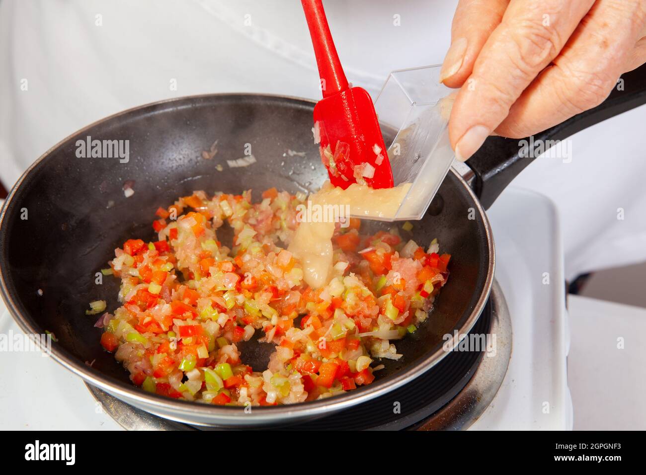 Preparation of the traditional Colombian hogao or criollo sauce (salsa ...