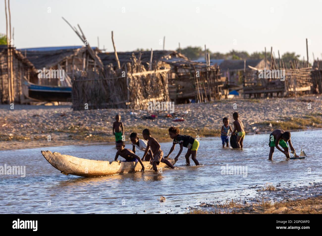 Madagascar, Menabe region, Morondava, children playing with a dugout ...