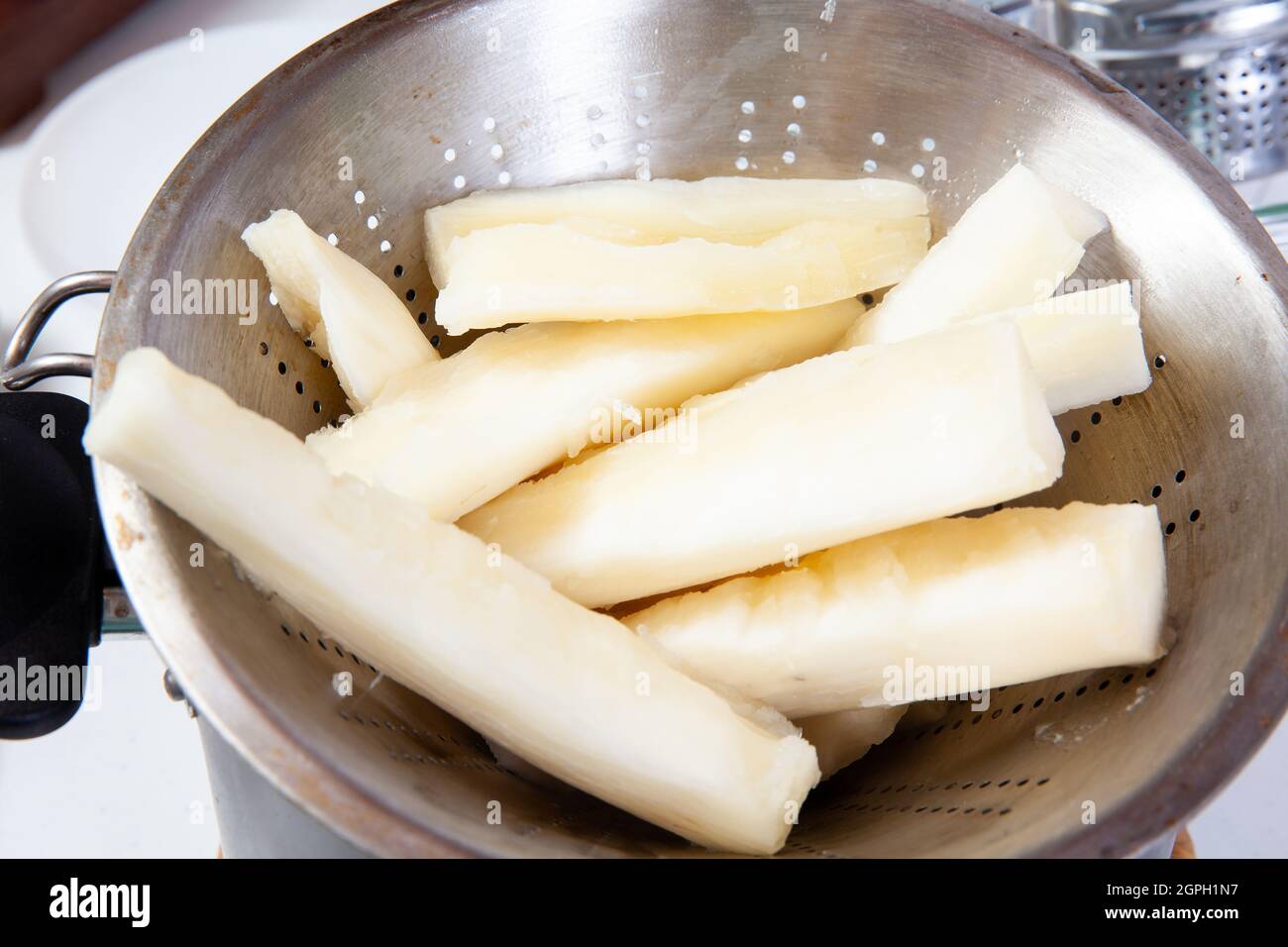 Preparation of a traditional Colombian fried stuffed yucca dumplings ...
