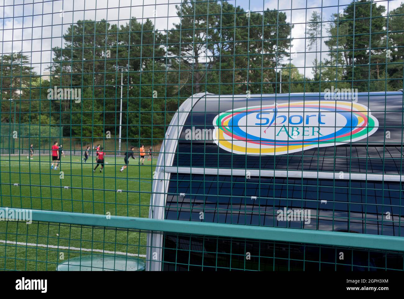 Students during Freshers' Week with bilingual signs in English and ...