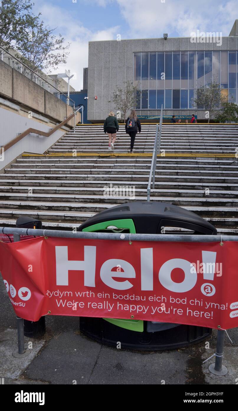Students during Freshers' Week with bilingual signs in English and ...