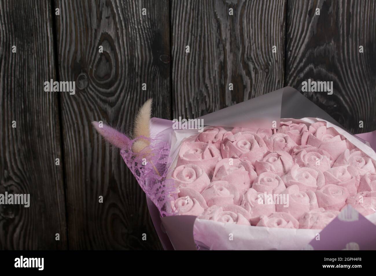 Marshmallow bouquet packed in craft paper. Zephyr rose flowers Stock Photo - Alamy