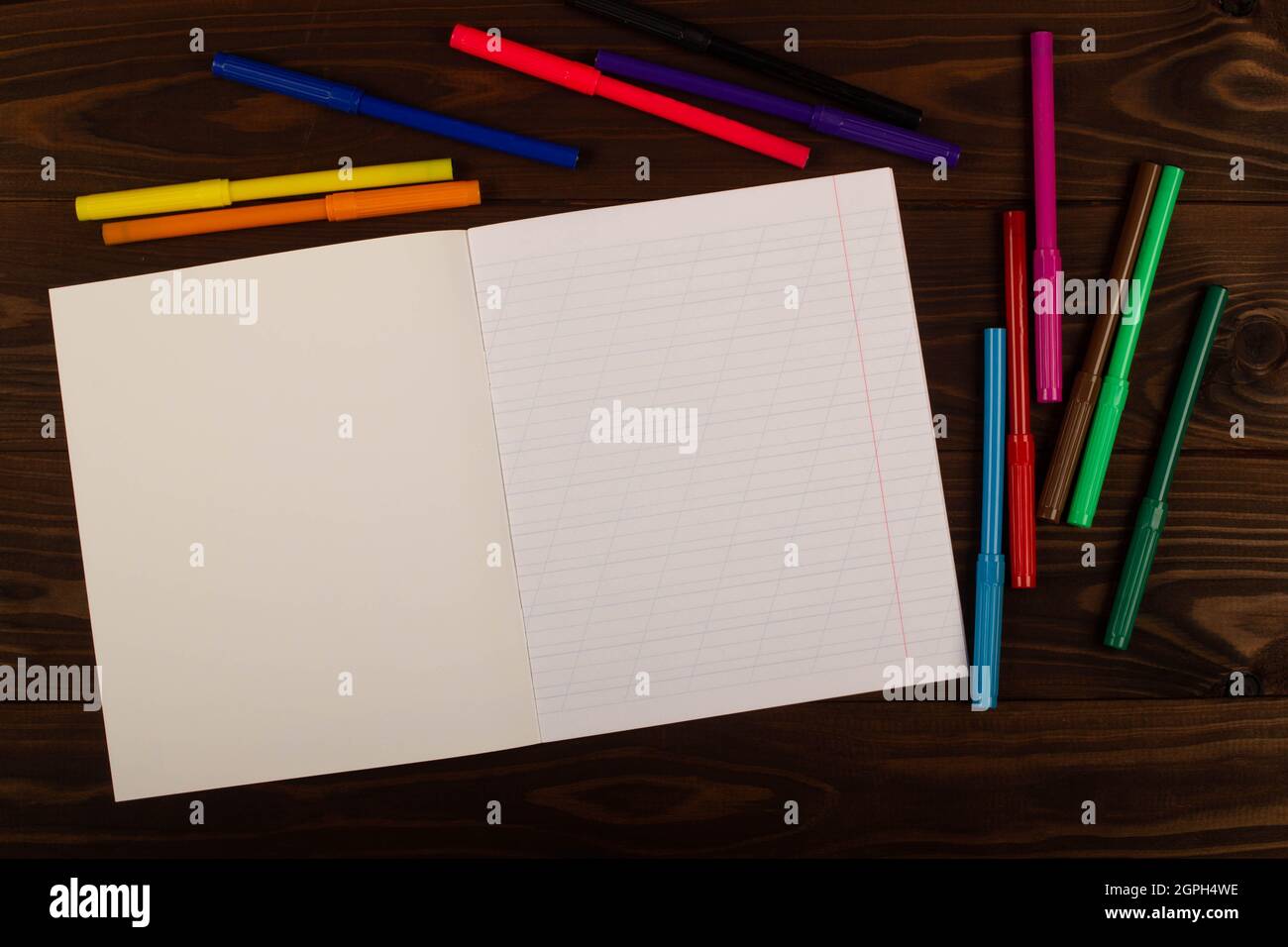 School notebook with oblique lines, colored felt-tip pen on the table ...