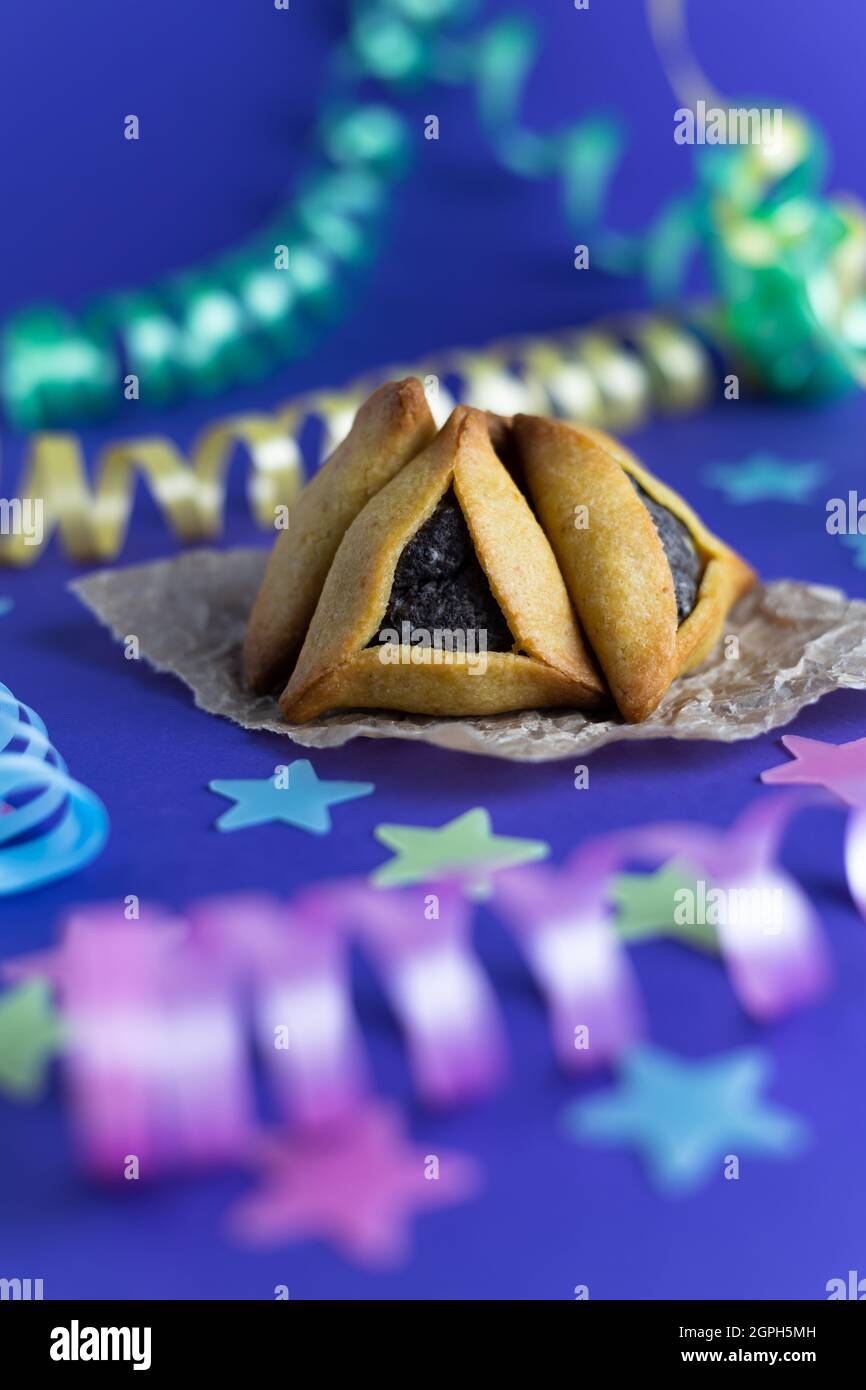 Traditional Jewish triangular hamantaschen cookies with poppy filling ...