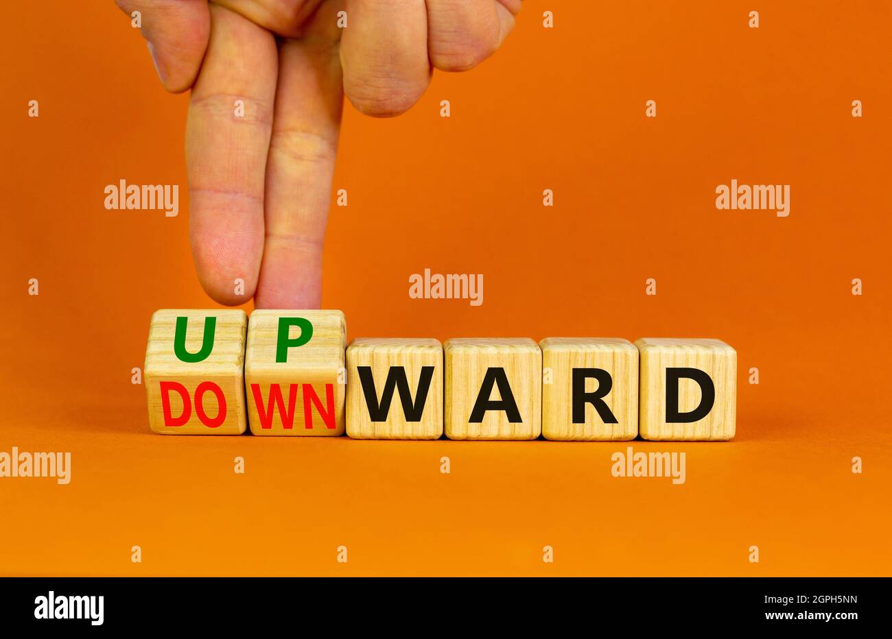 Upward or downward symbol. Businessman turns wooden cubes and changes ...