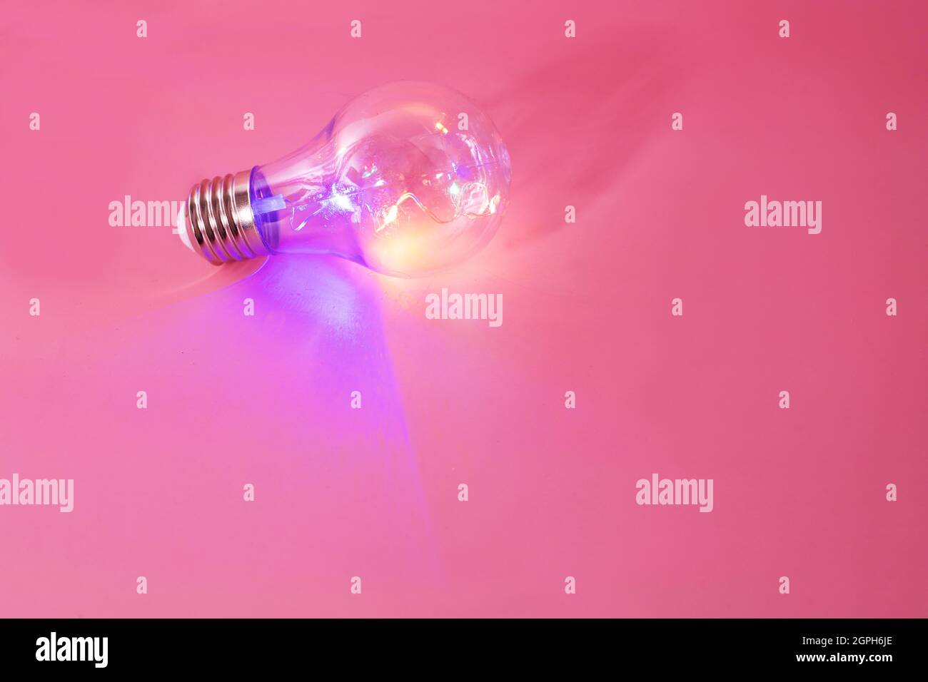 color light bulb on purple background Stock Photo - Alamy