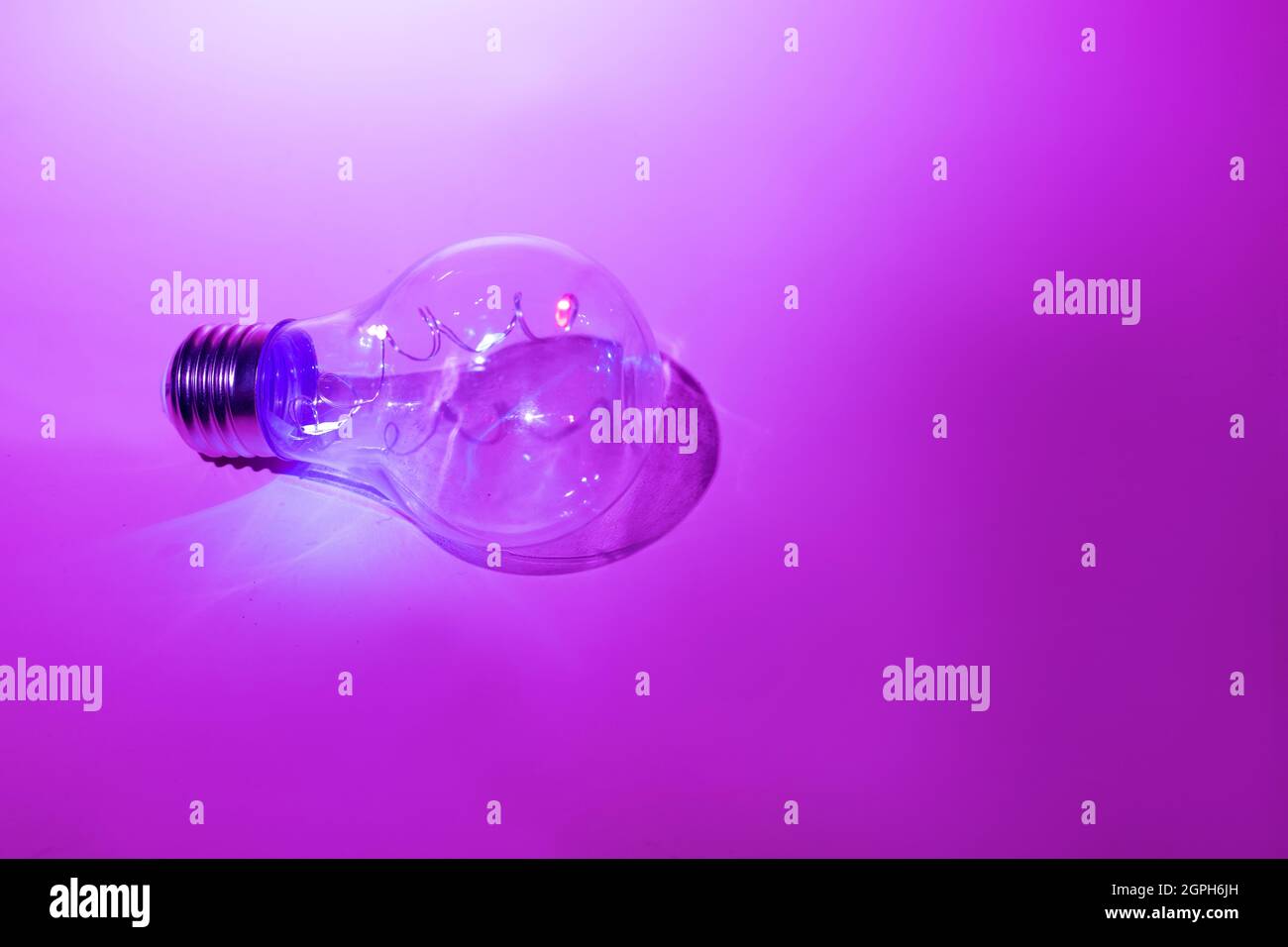 color light bulb on purple background Stock Photo - Alamy
