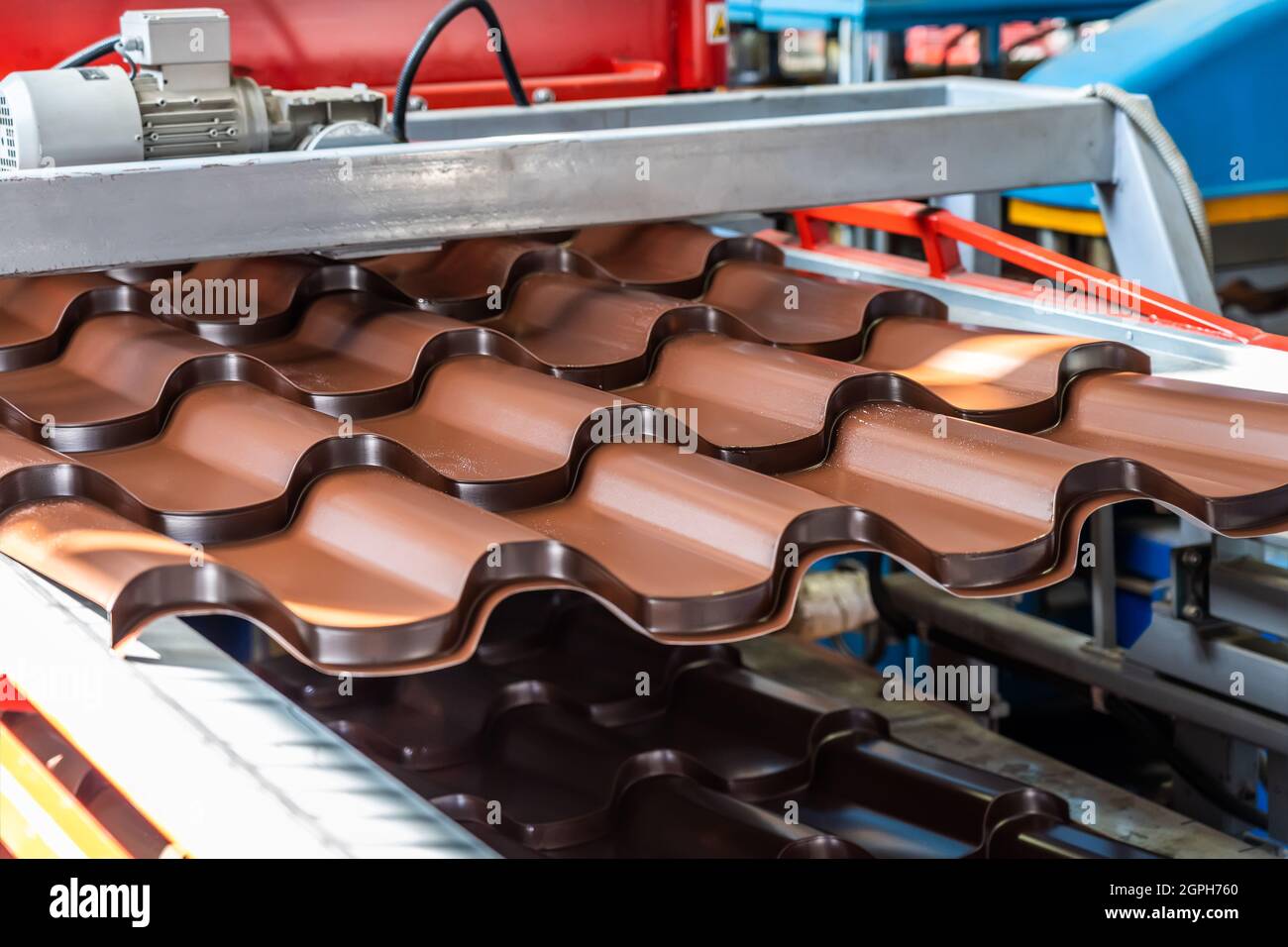 Metal tile for roof in metal forming machine production line close up ...