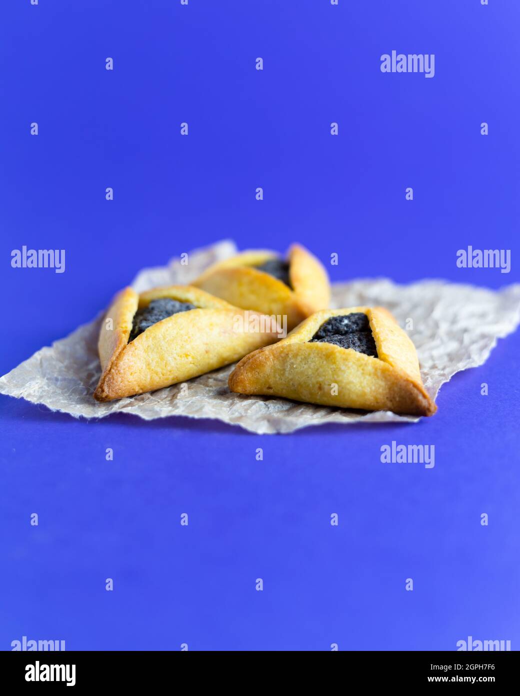 Traditional Jewish triangular hamantaschen cookies with poppy filling ...