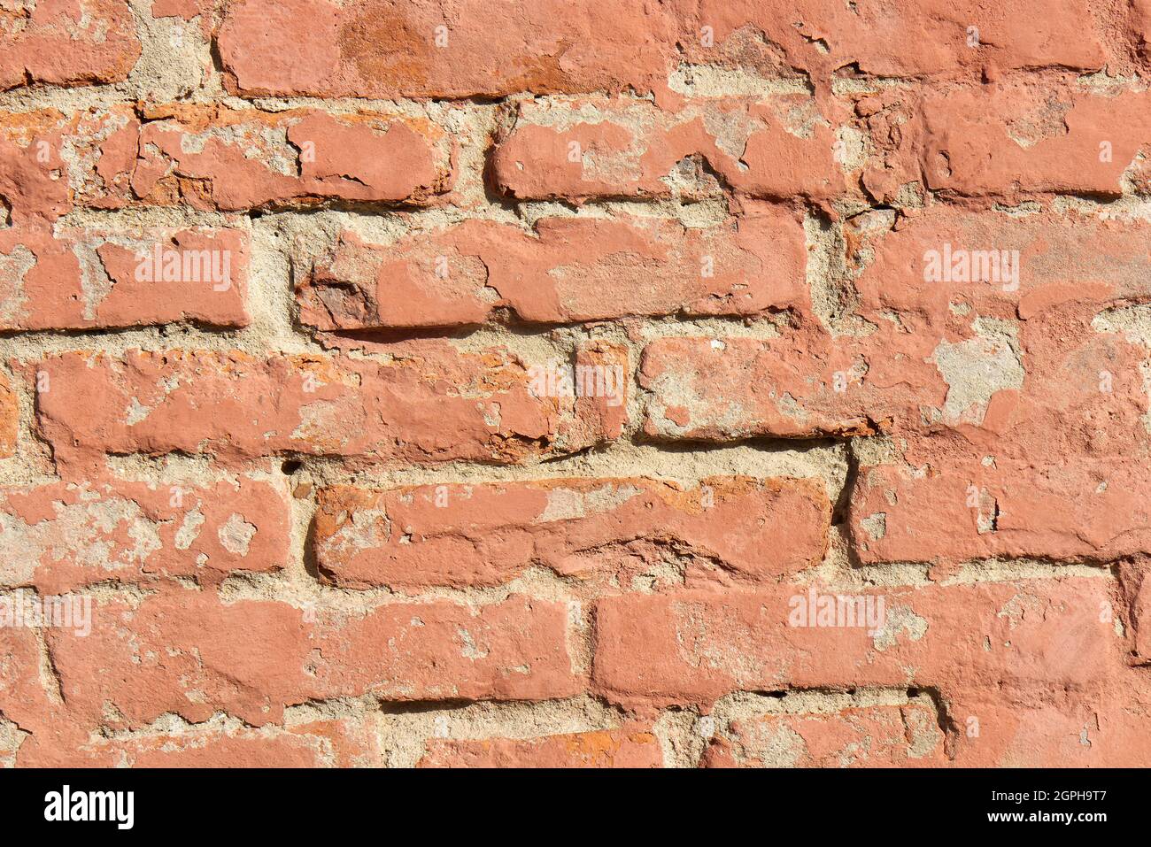 Brick wall pattern. Old wall built from the red bricks with remnants of ...
