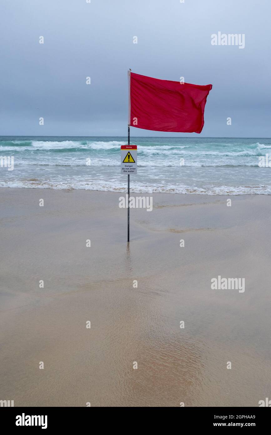 A Red Lifeguards Warning Flag (With Warning Sign) On A Cornish Beach ...