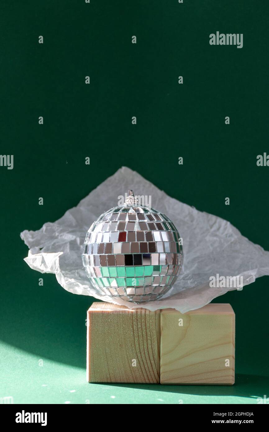 Still life with wooden cubes and disco ball reflecting sun flares ...