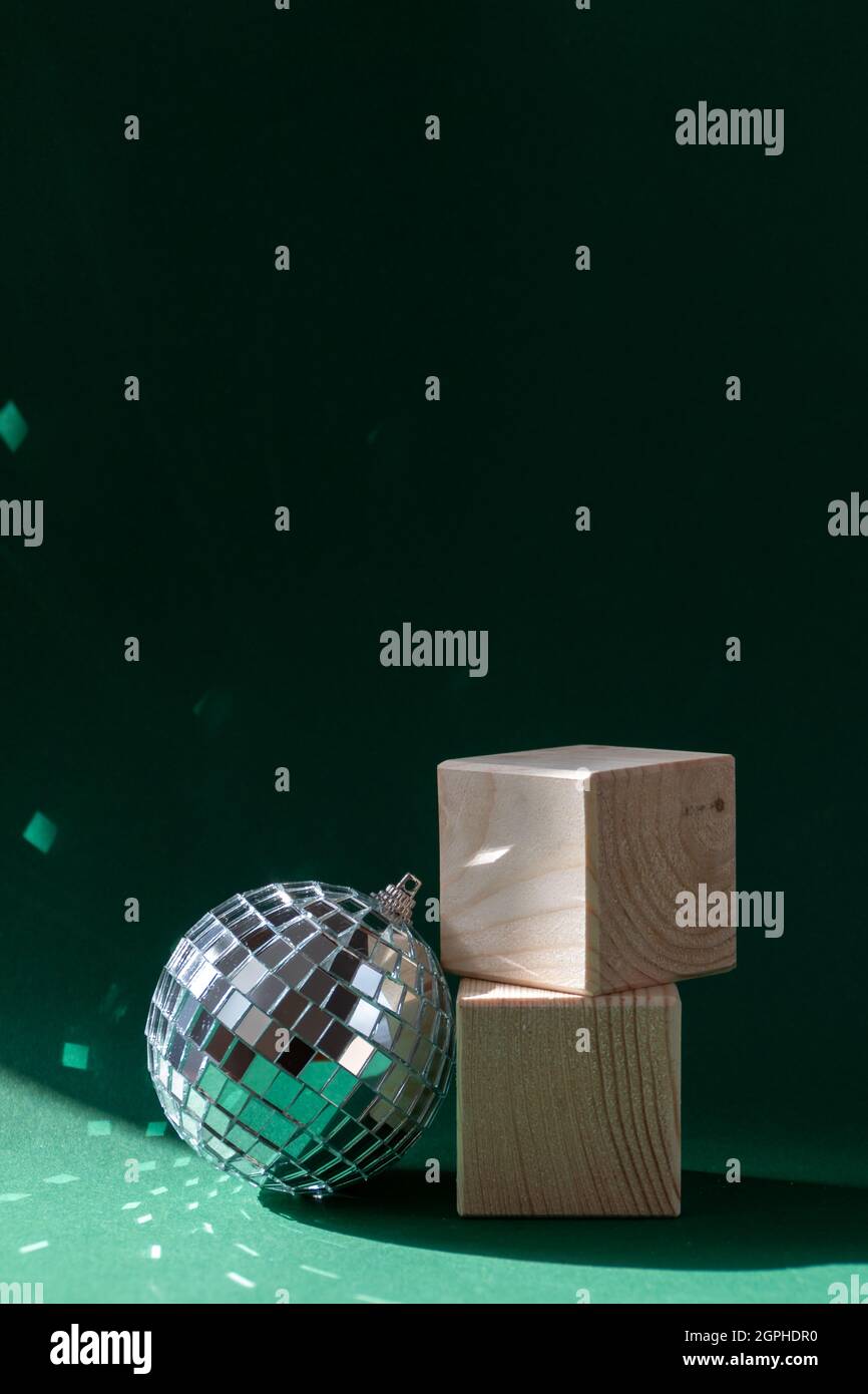 Still life with wooden cubes and disco ball reflecting sun flares ...