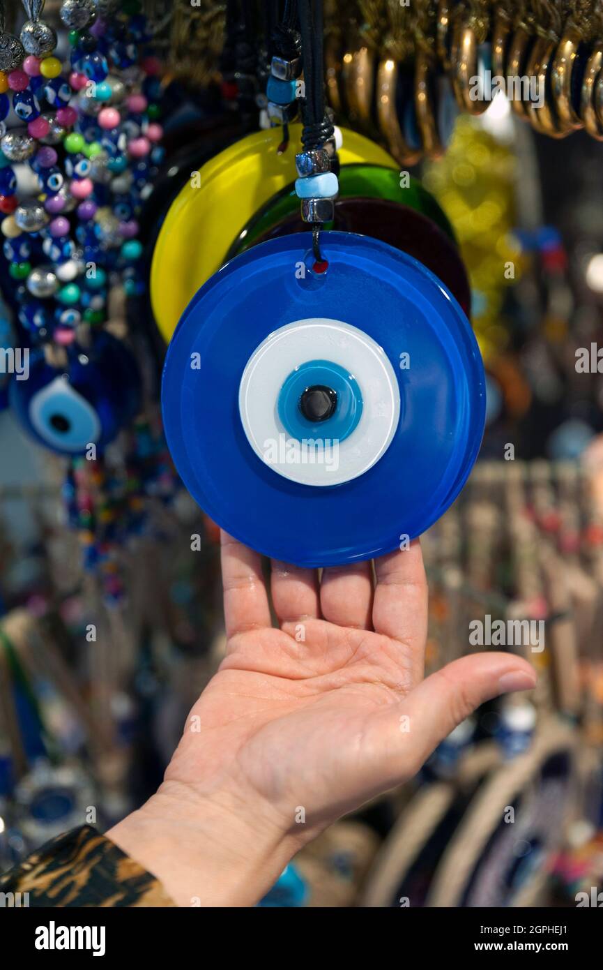 Big evil eye bead in female hand stock photo Stock Photo - Alamy