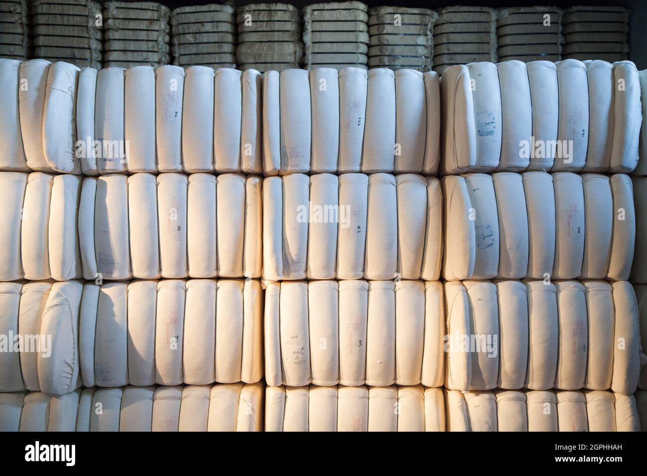 Raw cotton bales in textile factory Stock Photo - Alamy