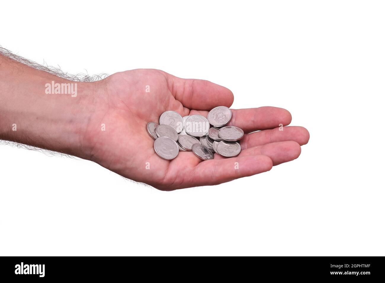 a handful of metal coins in the man's hand Stock Photo - Alamy