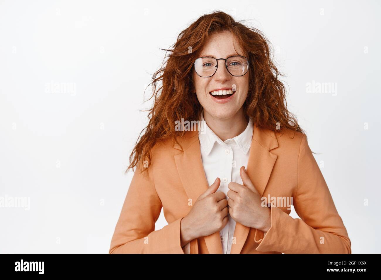Happy young female trainee dressed as office worker, holding hands on ...