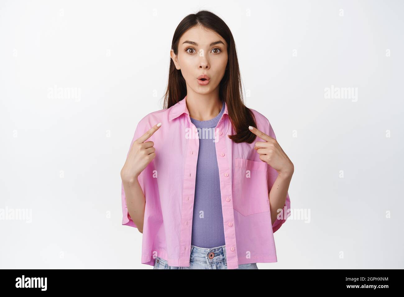 Surprised woman say wow, pointing at herself, who me gesture, being ...