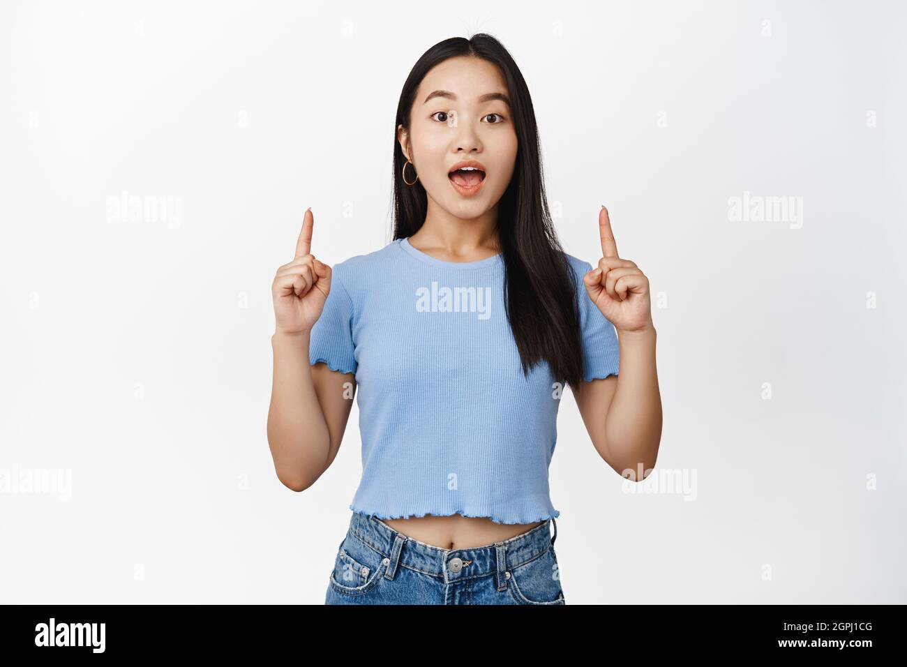 Asian woman pointing upwards hi-res stock photography and images - Alamy