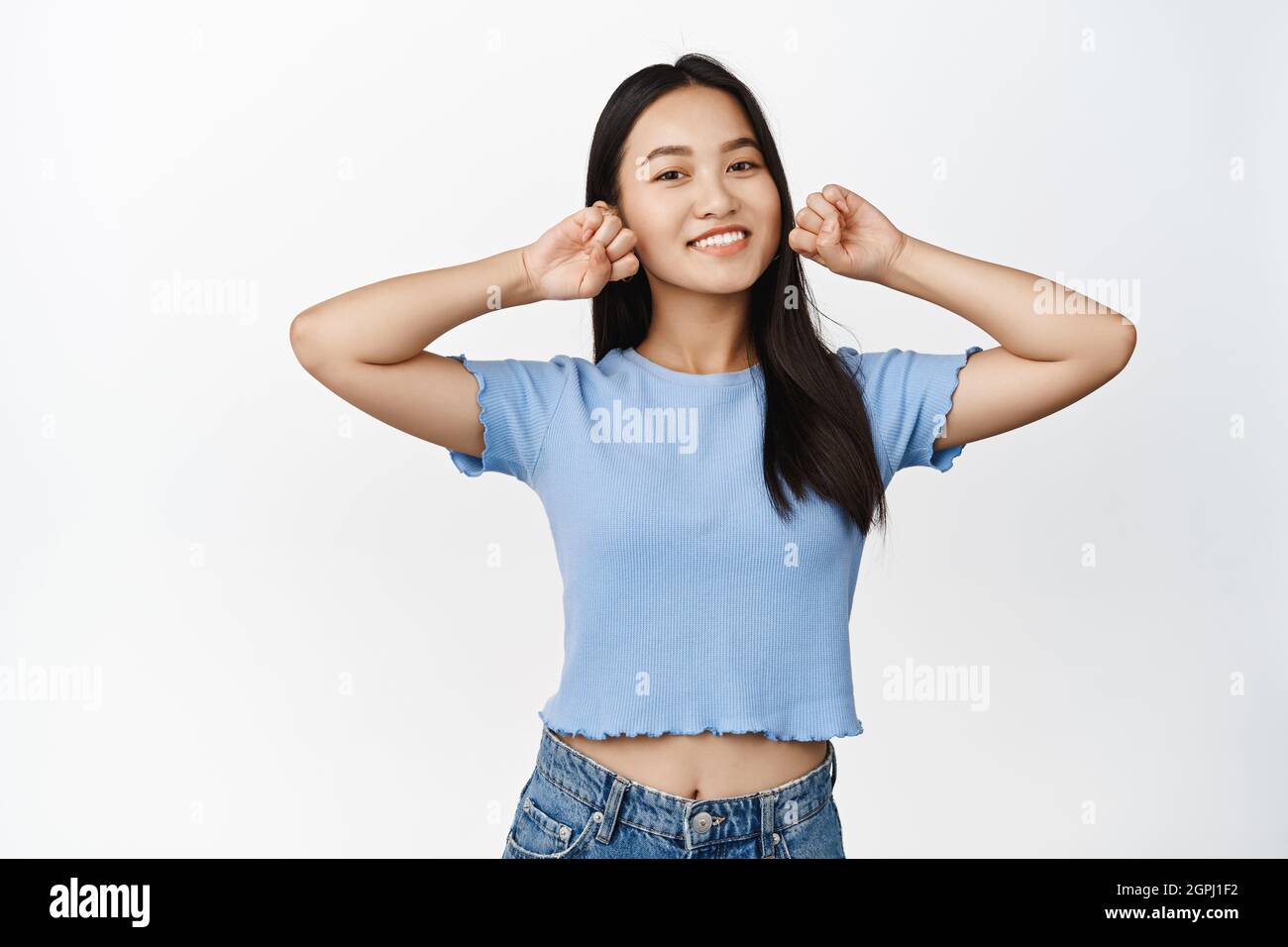 Cute smiling asian girl shows kawaii cat paws gesture and looking happy ...