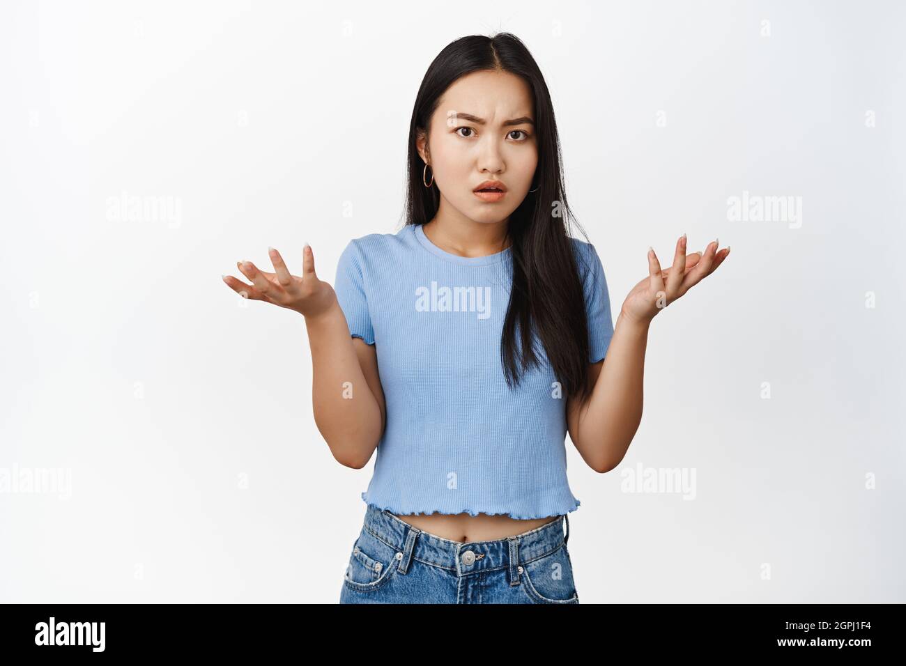 Frustrated and clueless asian woman shrugging, cant understand ...