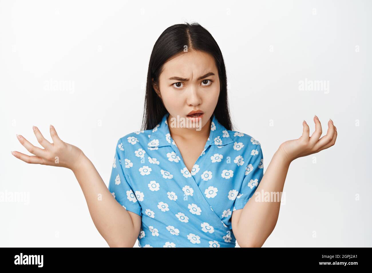 Close up of confused and annoyed asian woman shrugging with spread ...