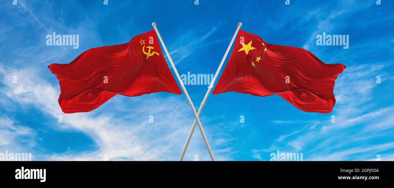 flags of China and ussr waving in the wind on flagpoles against sky ...
