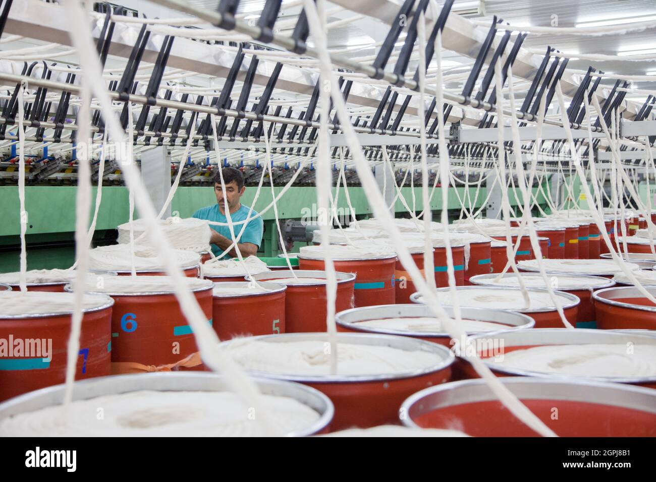 Istanbul / Turkey - 08/26/2014: An unknown worker working in a textile ...
