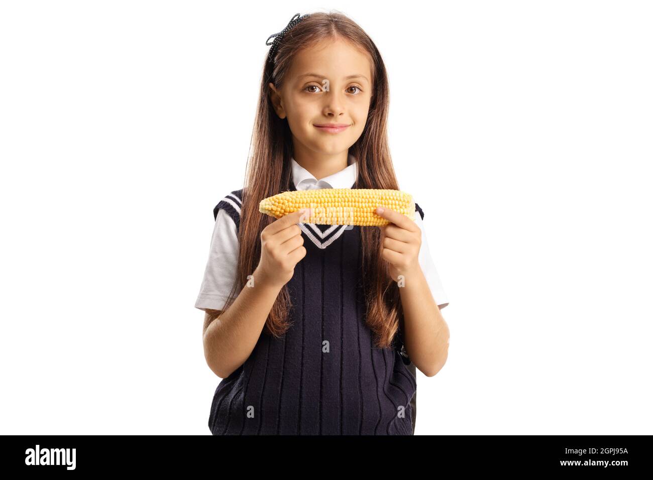 Schoolgirl in a uniform eating corn on the cob isolated on white ...