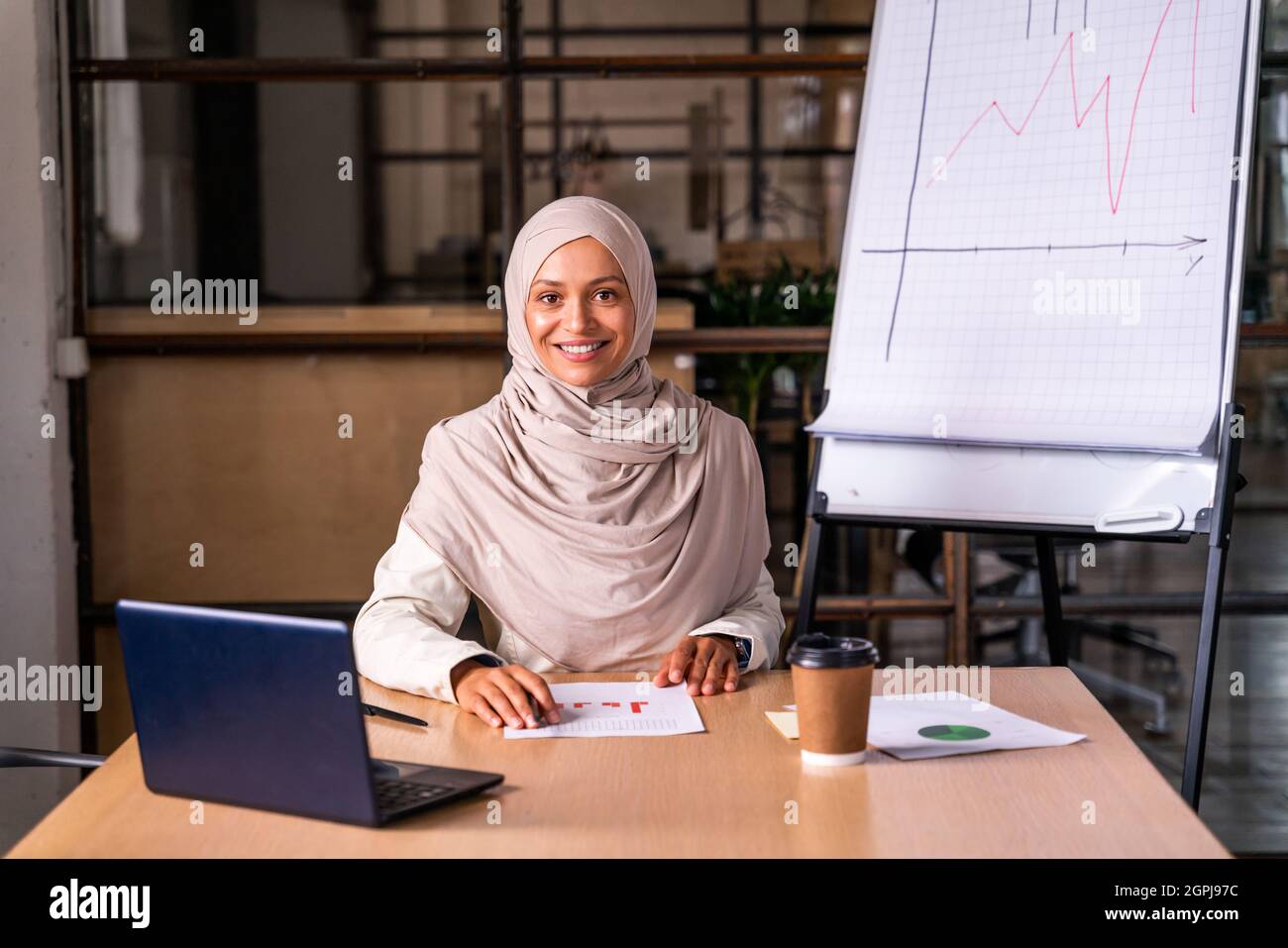 Beautiful middle-eastern businesswoman wearing hijab working in her ...